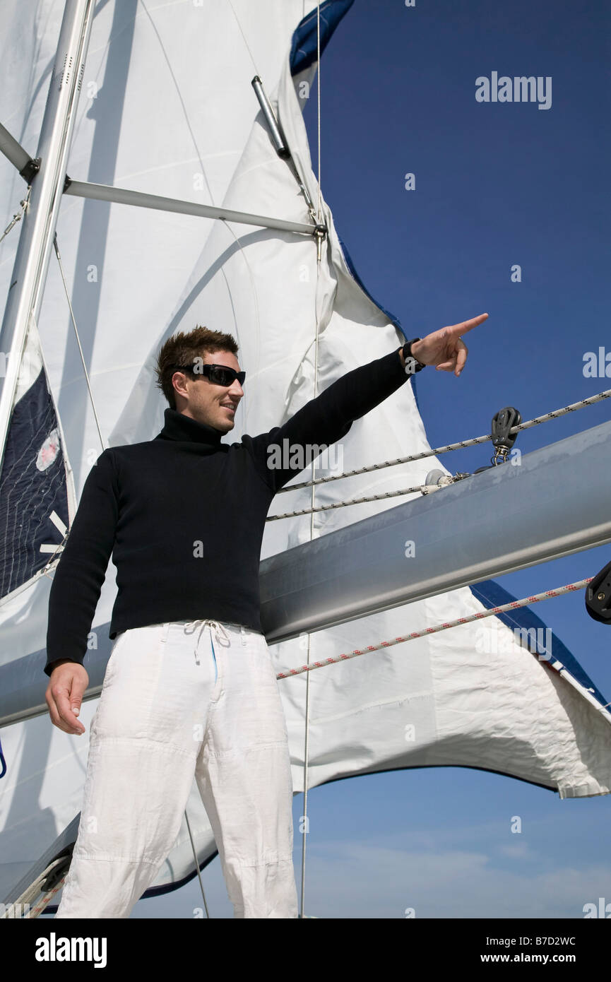 A man standing on a yacht and pointing Stock Photo - Alamy