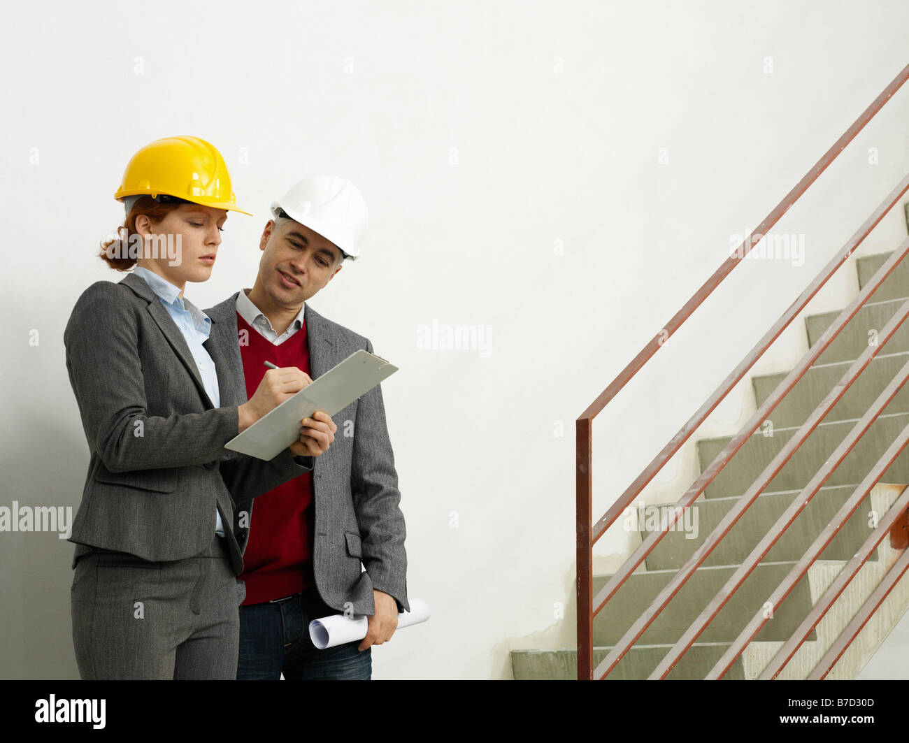 Two architects working on a construction site Stock Photo - Alamy