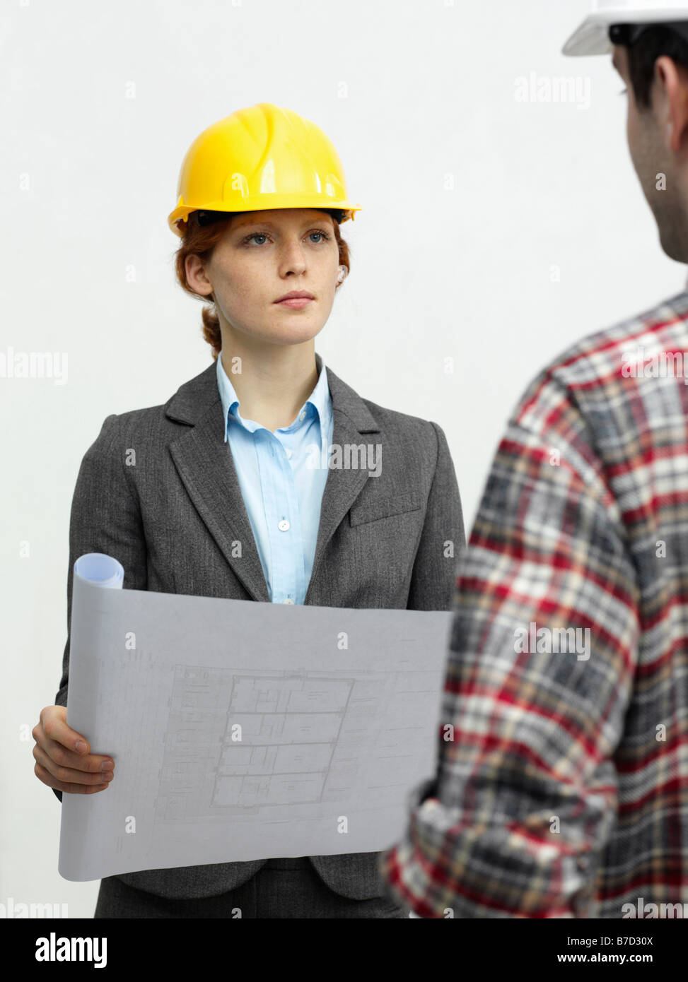 An architect speaking with a construction worker Stock Photo - Alamy