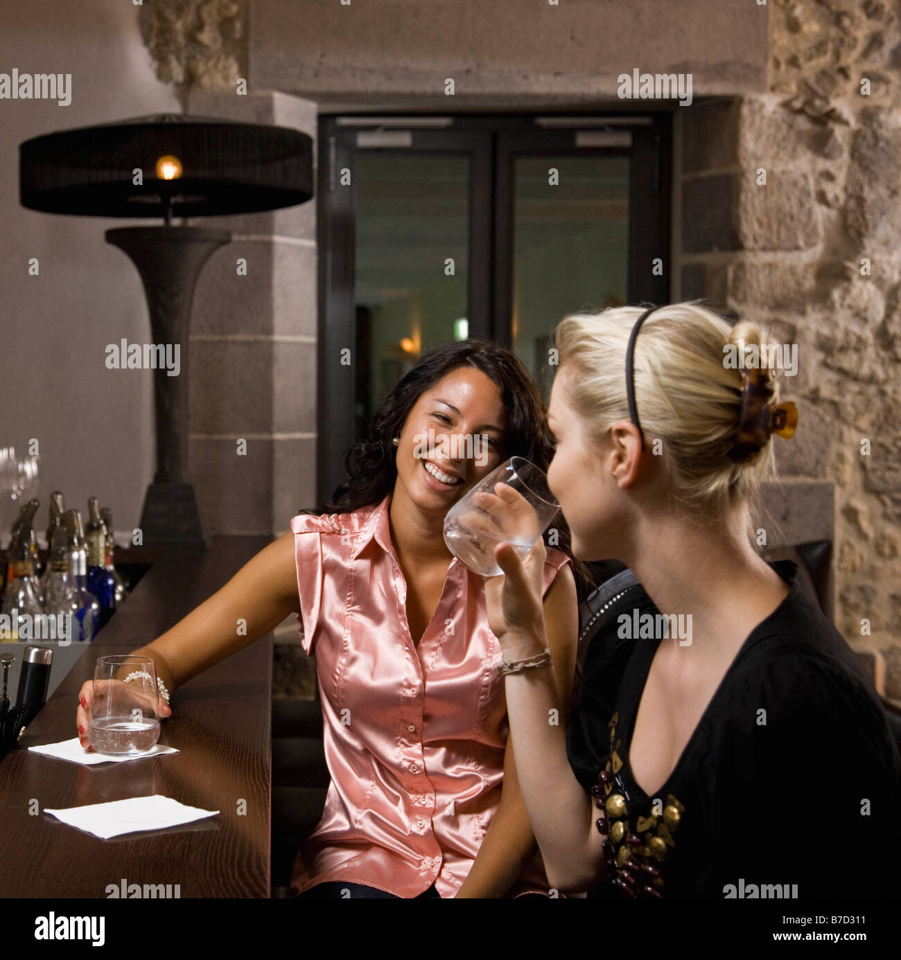 Women drinking and talking at a bar Stock Photo - Alamy