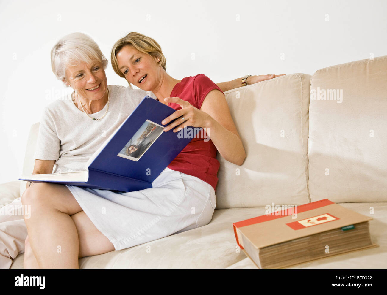 Women talking over photos Stock Photo - Alamy