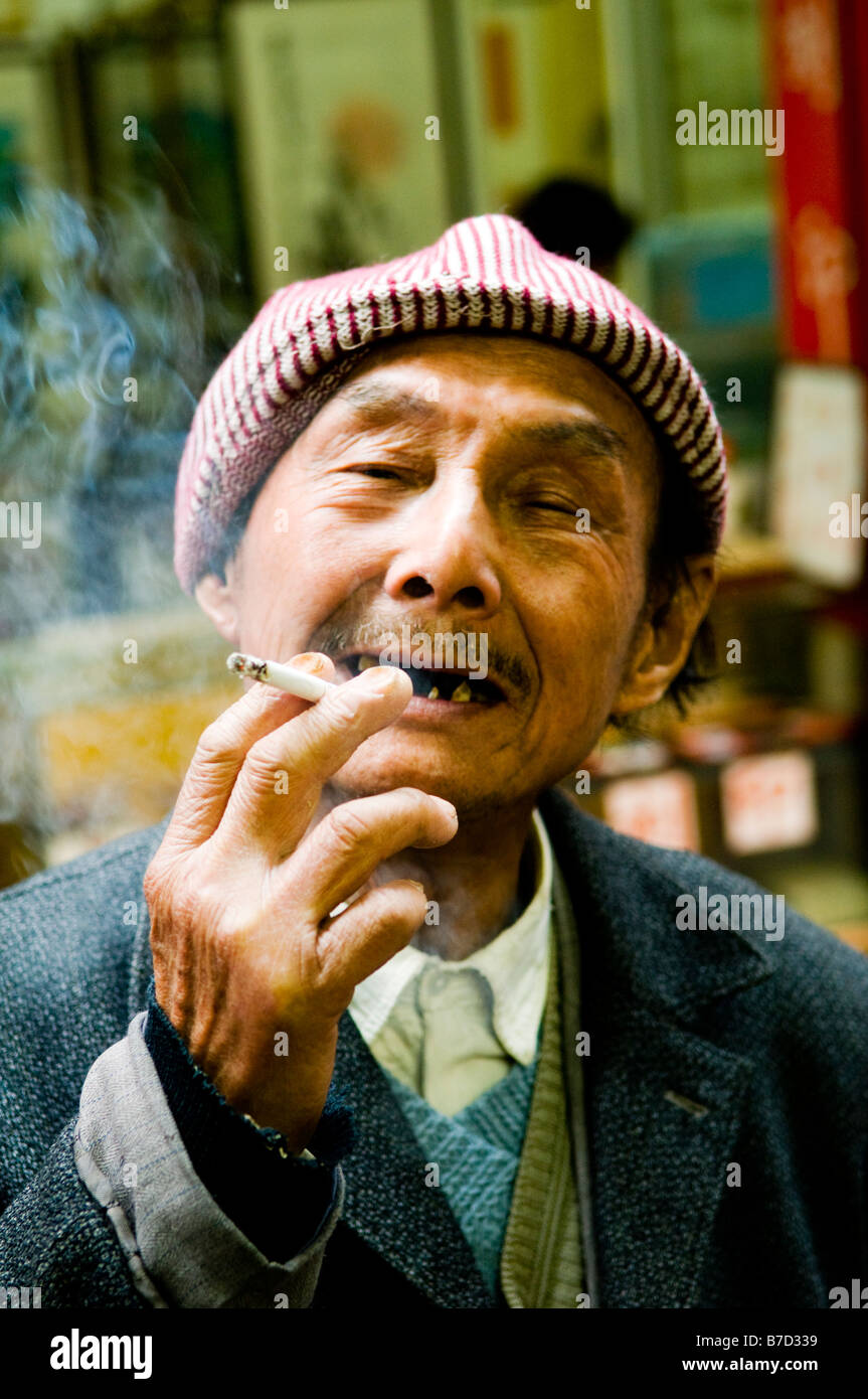 Portrait of a Chinese man smoking a cigarette Stock Photo - Alamy