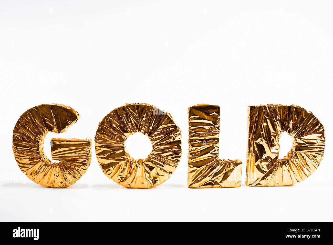 The word GOLD wrapped in gold foil Stock Photo - Alamy