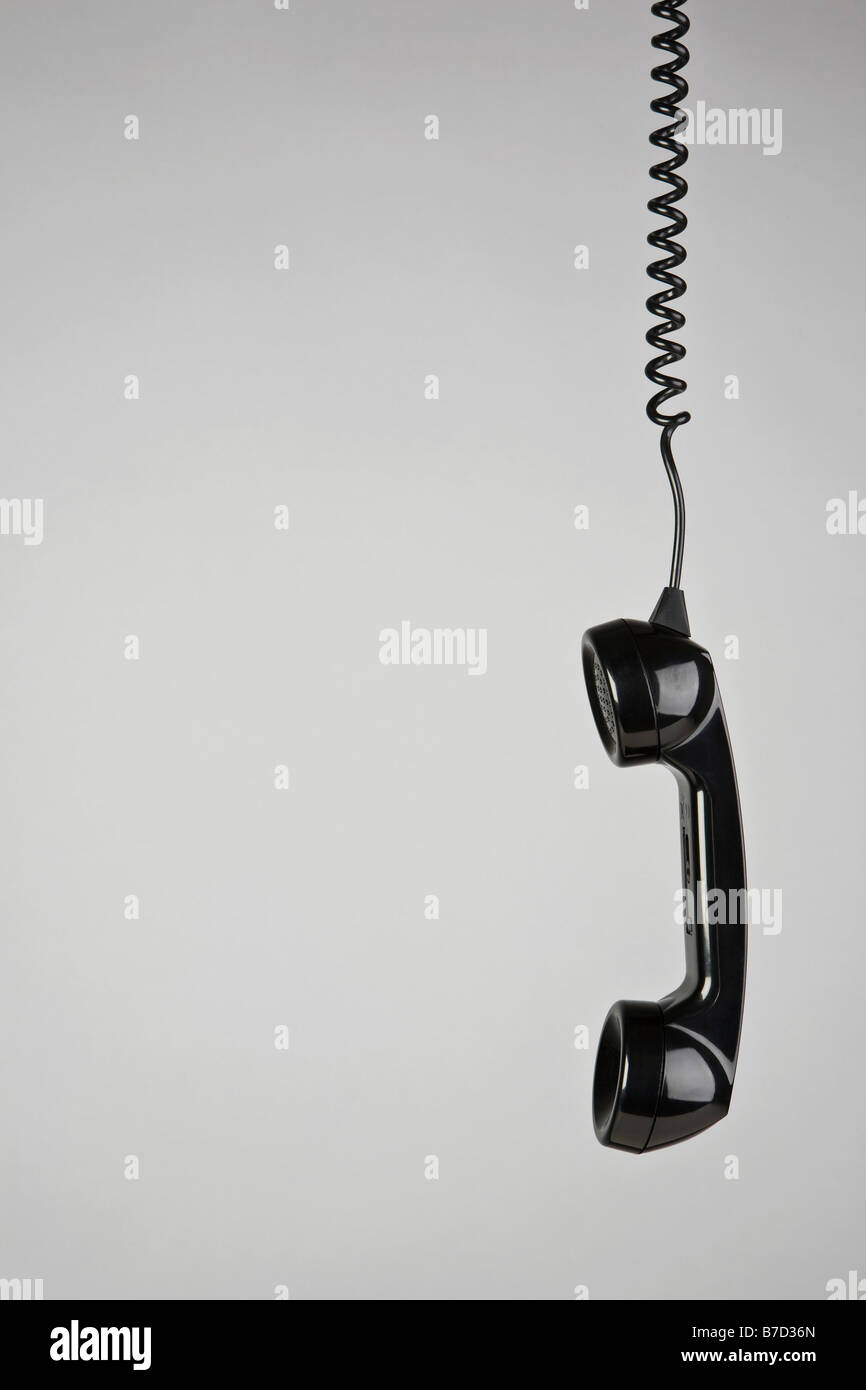 A telephone receiver hanging Stock Photo - Alamy