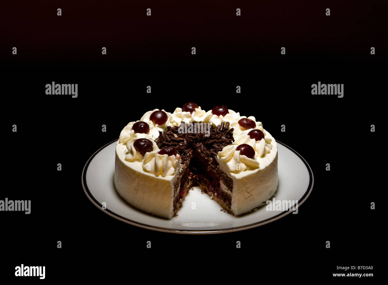 A cake on a plate with a slice missing Stock Photo - Alamy