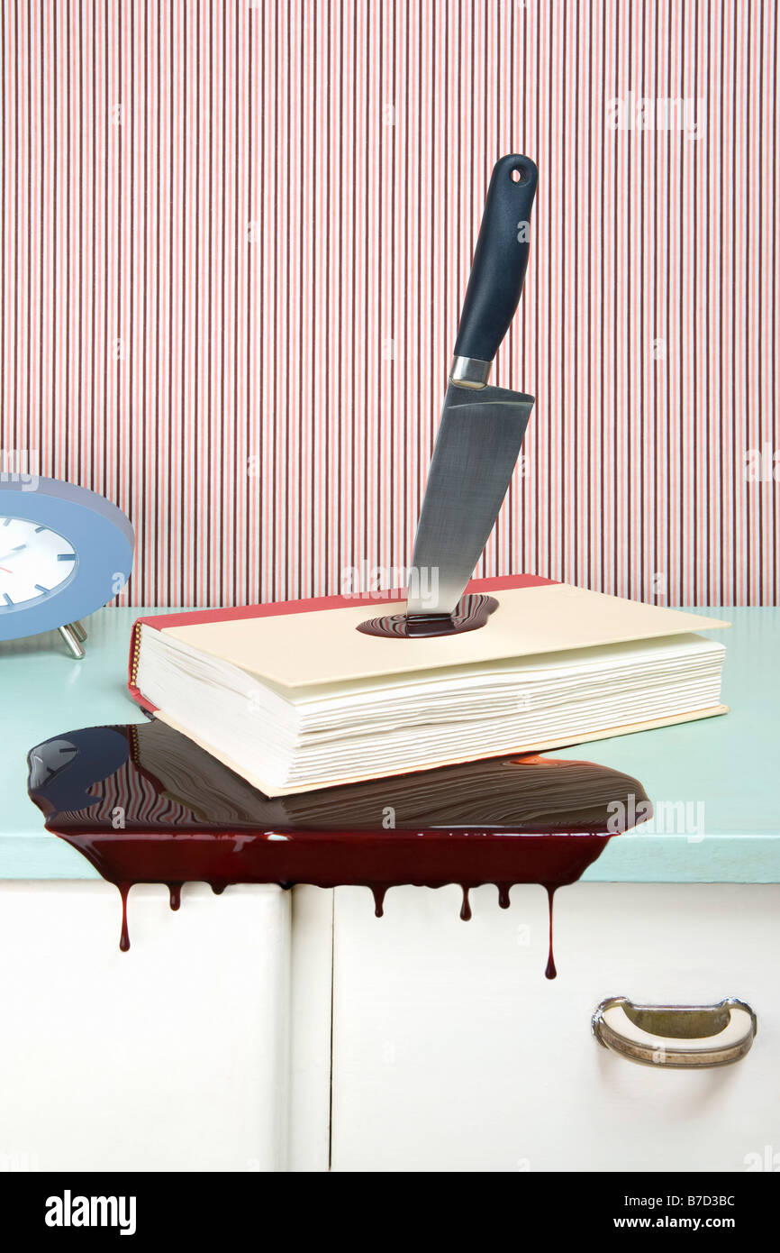 Knife stabbing a book on a dresser Stock Photo - Alamy