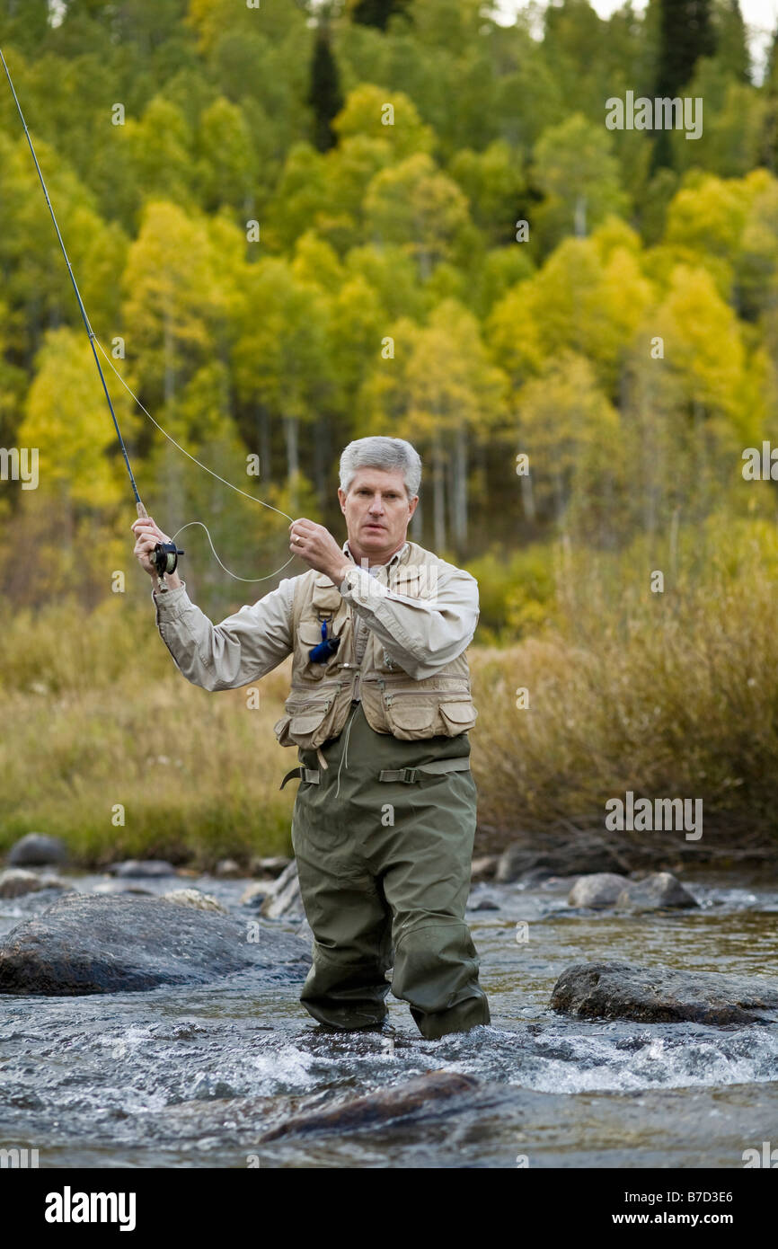 A man fly fishing in a river Stock Photo - Alamy