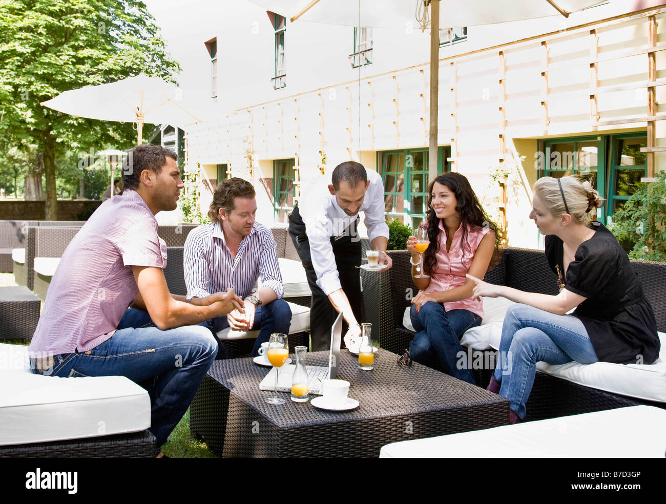 Men and women talking over drinks Stock Photo - Alamy