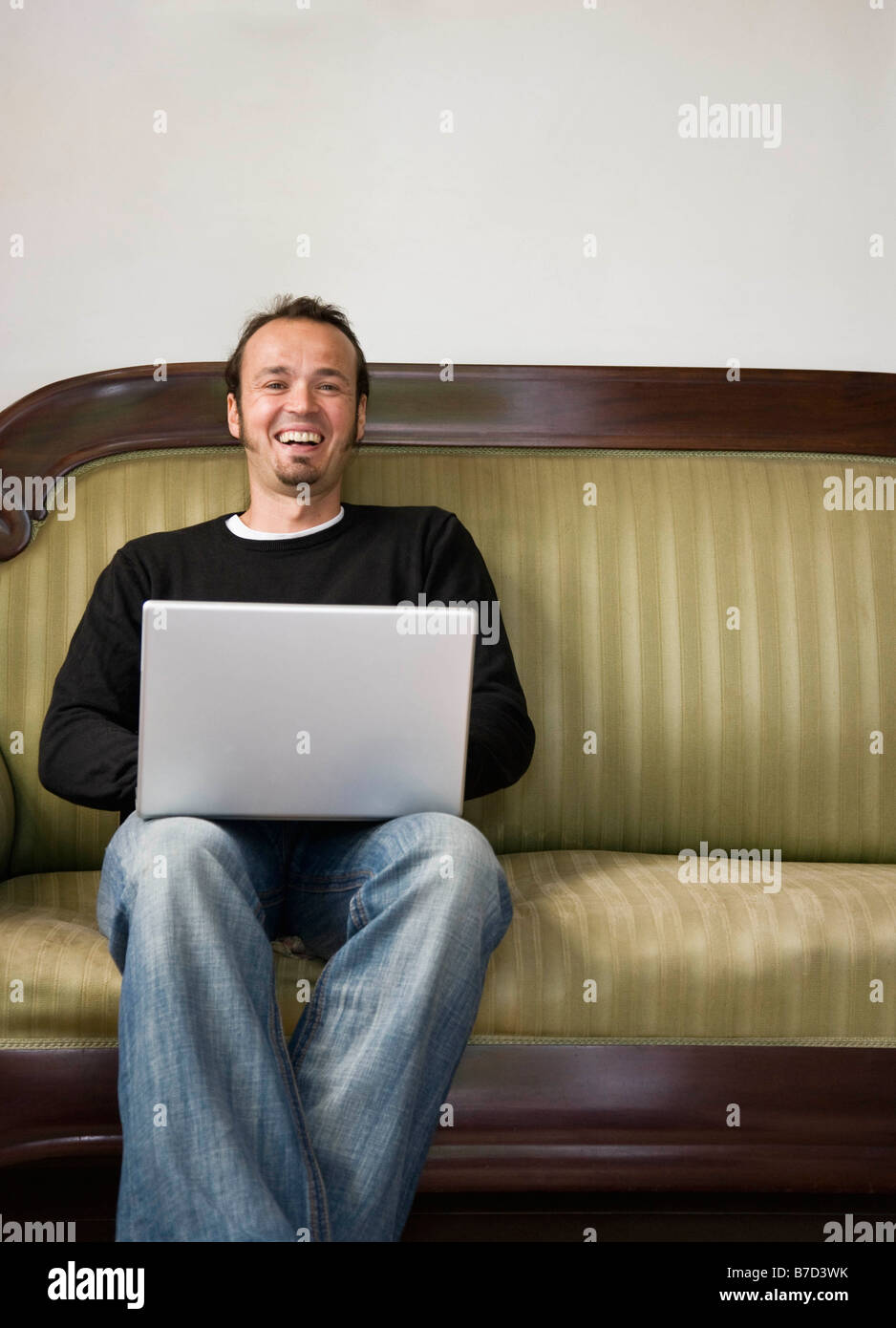 Man working on a laptop computer Stock Photo - Alamy