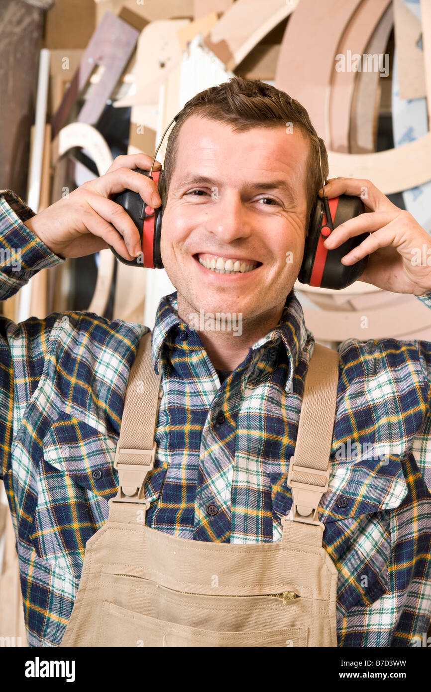 A carpenter with ear protectors Stock Photo - Alamy