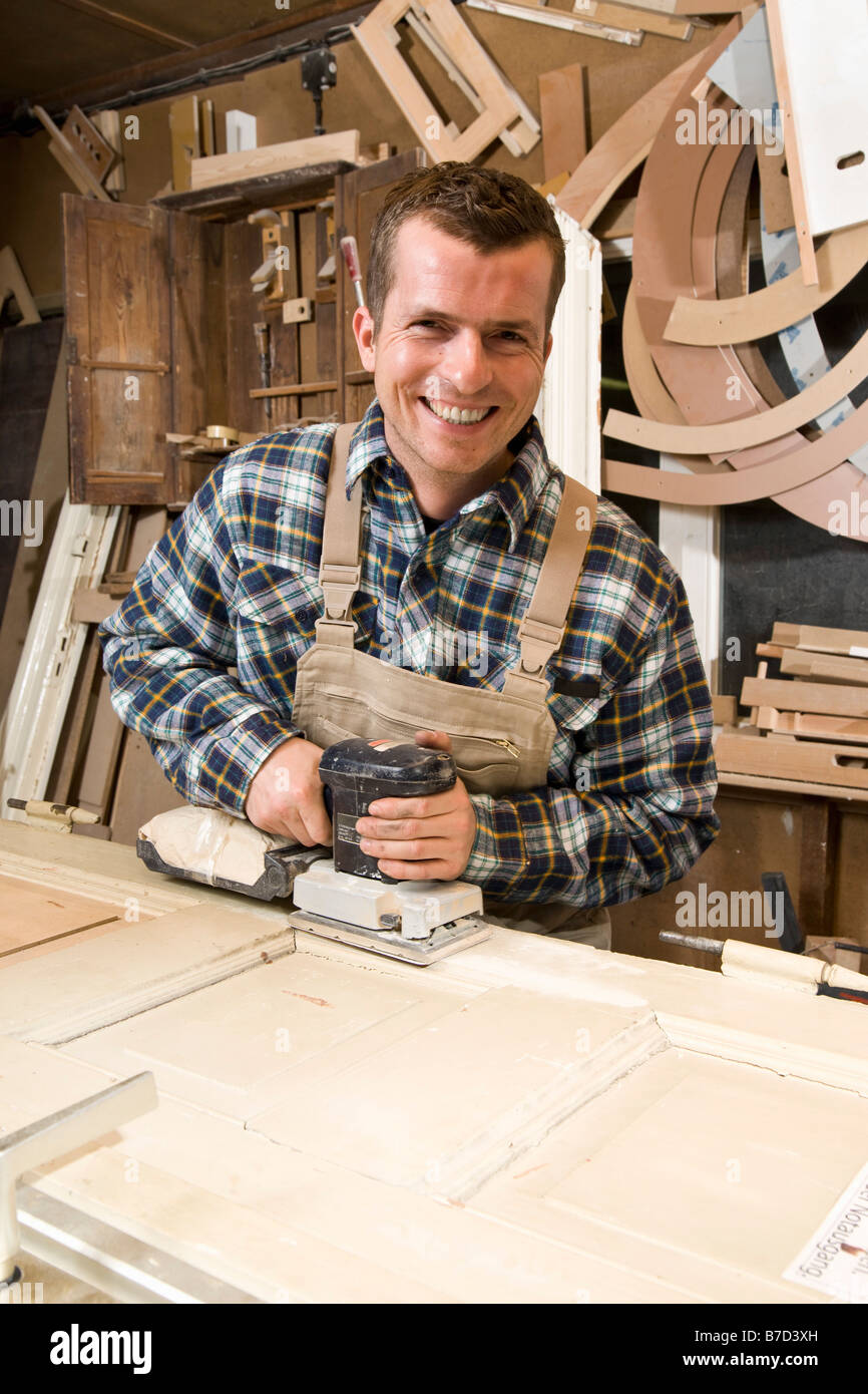A carpenter using a plane Stock Photo - Alamy