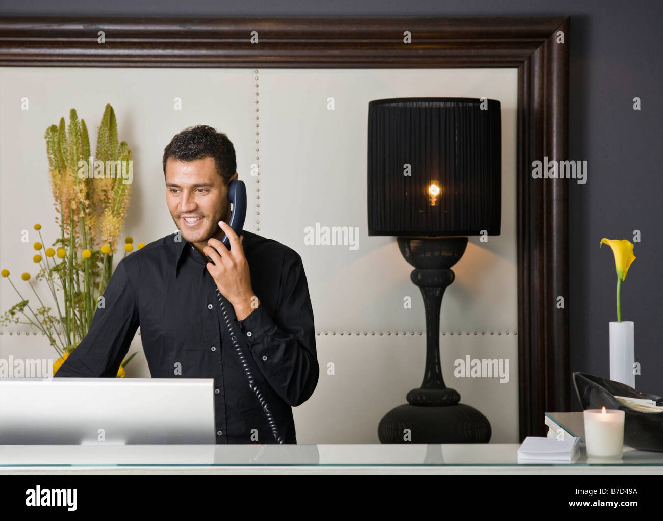 Male receptionist talking on the phone Stock Photo, Royalty Free Image ...