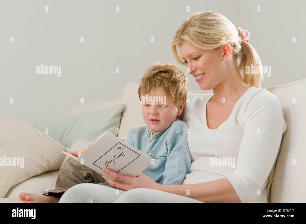 A mother reading to her child Stock Photo - Alamy