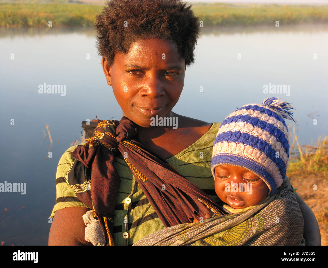 Woman of Bemba tribe with baby selling charcoal on Luapula or Congo ...
