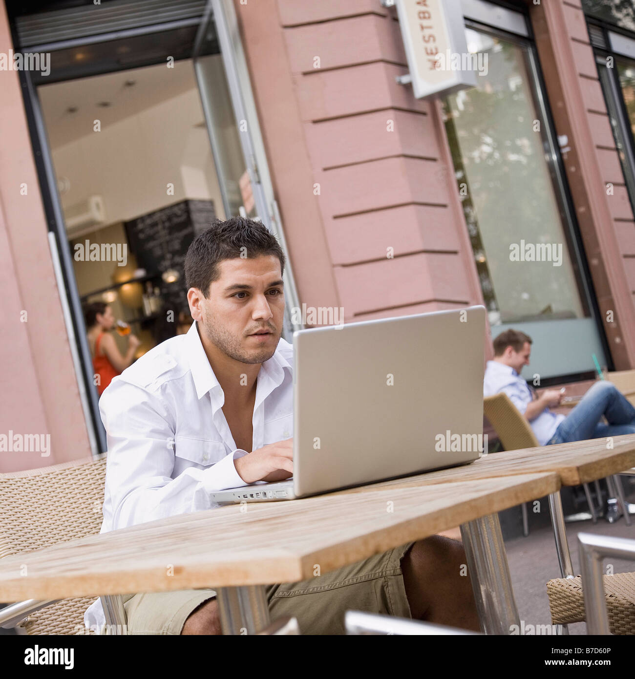 Man outside on laptop Stock Photo - Alamy