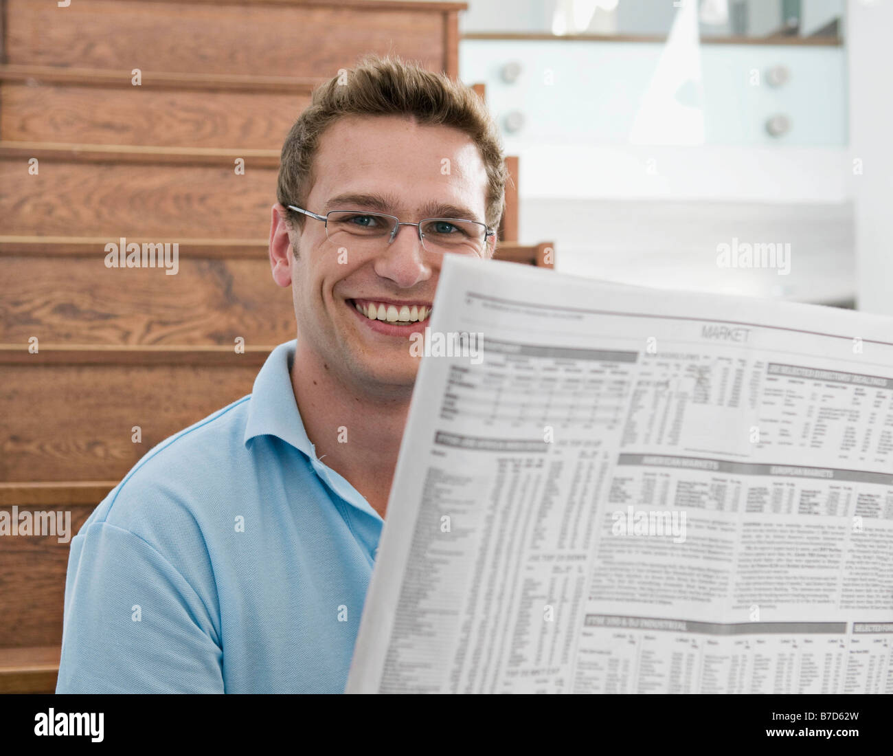 Male reading the paper Stock Photo - Alamy