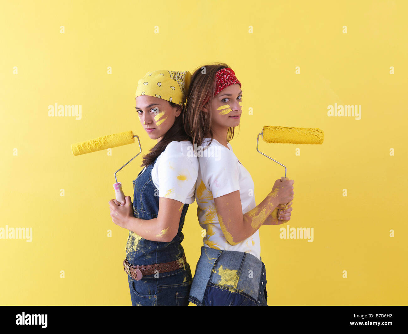 Girls posing in front of wall Stock Photo - Alamy