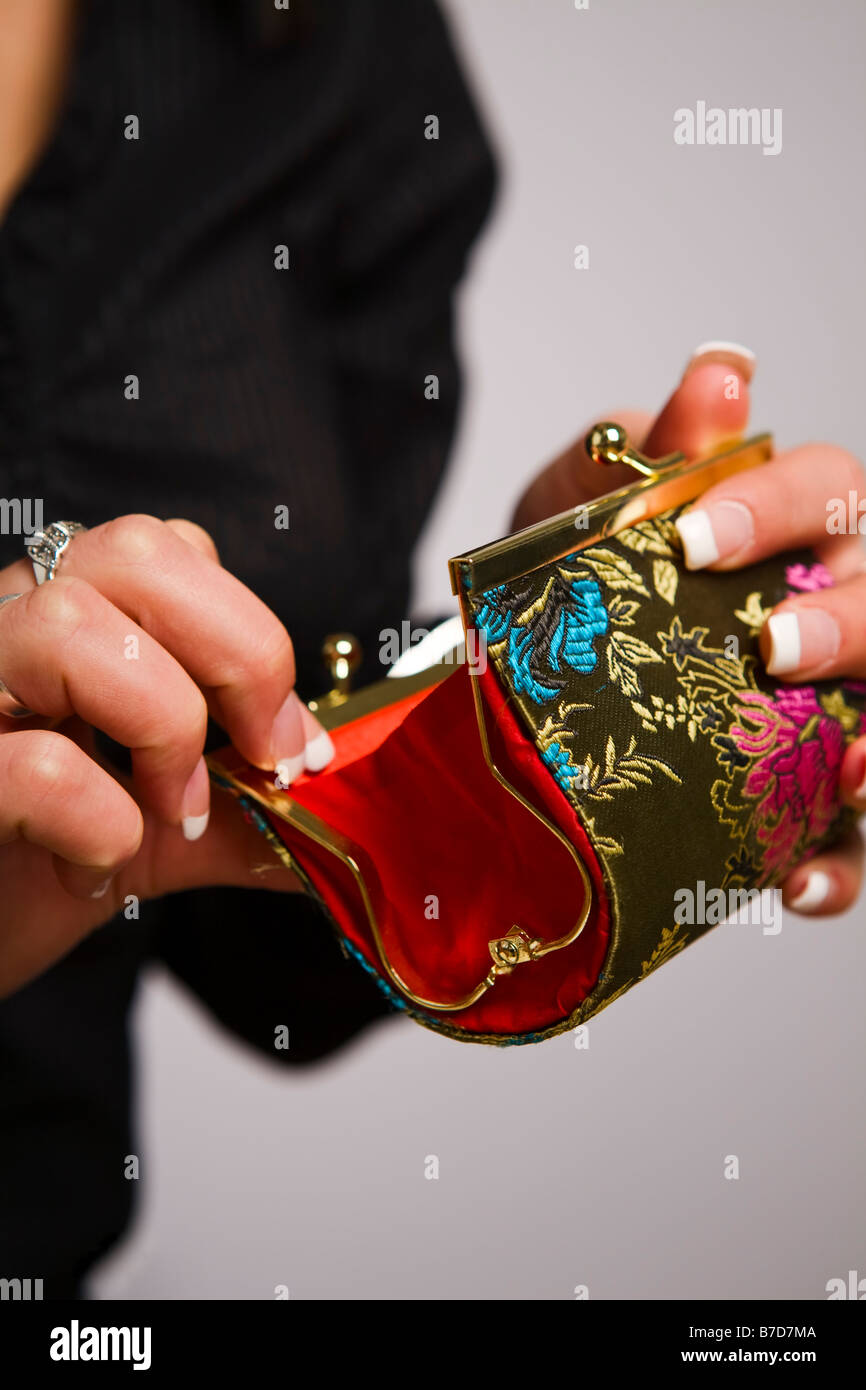 Woman's hands opening empty coin purse Stock Photo - Alamy
