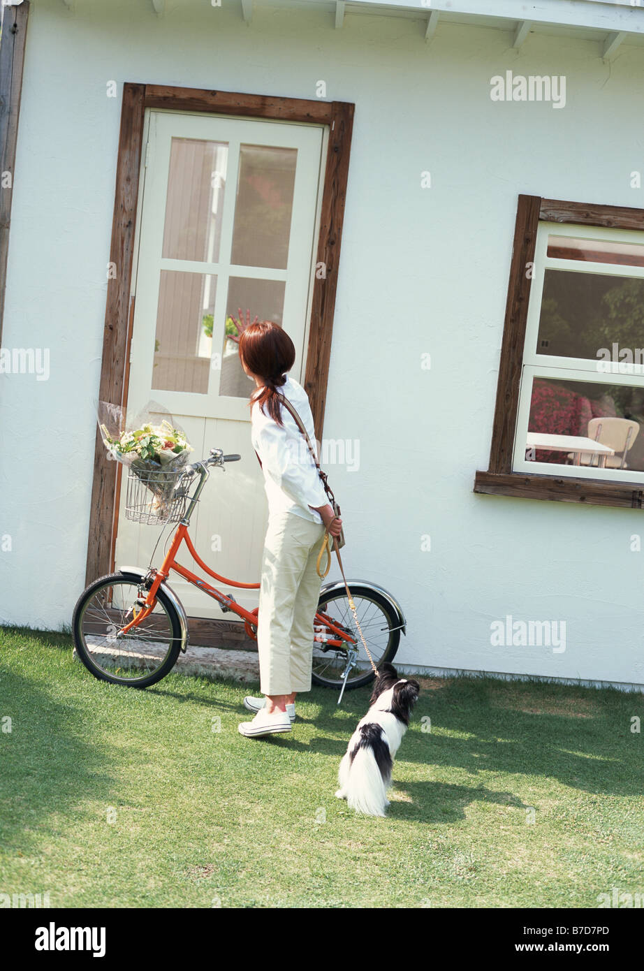 Woman going out with dog Stock Photo - Alamy