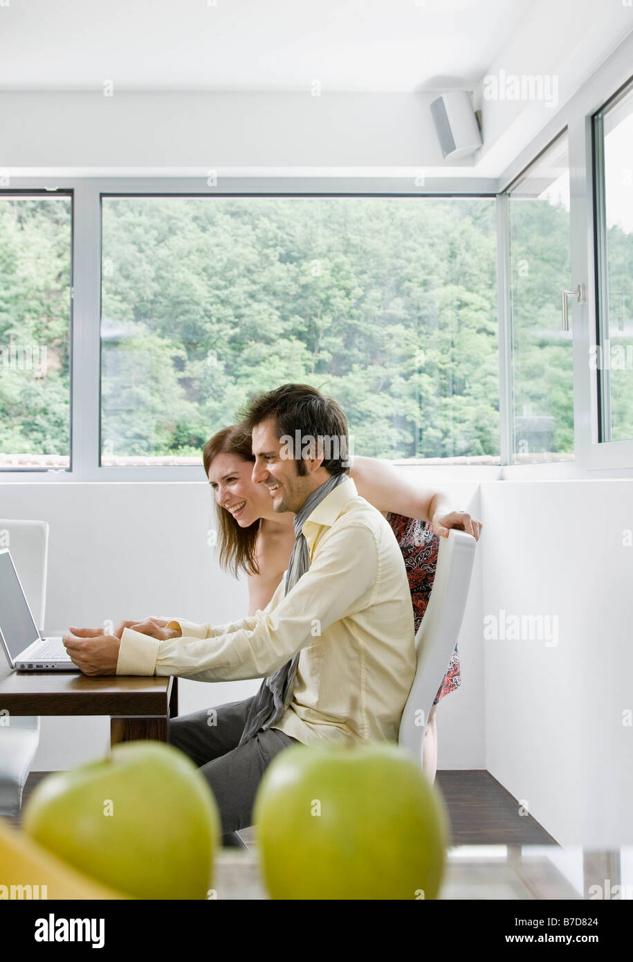 Man and woman looking at laptop computer Stock Photo - Alamy