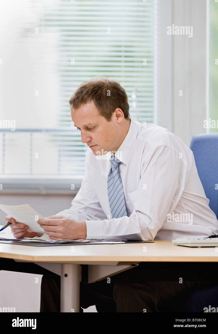 Man working on paperwork Stock Photo - Alamy