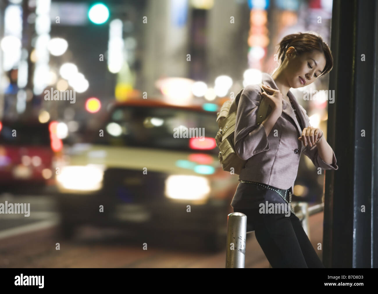 Woman in street corner Stock Photo - Alamy