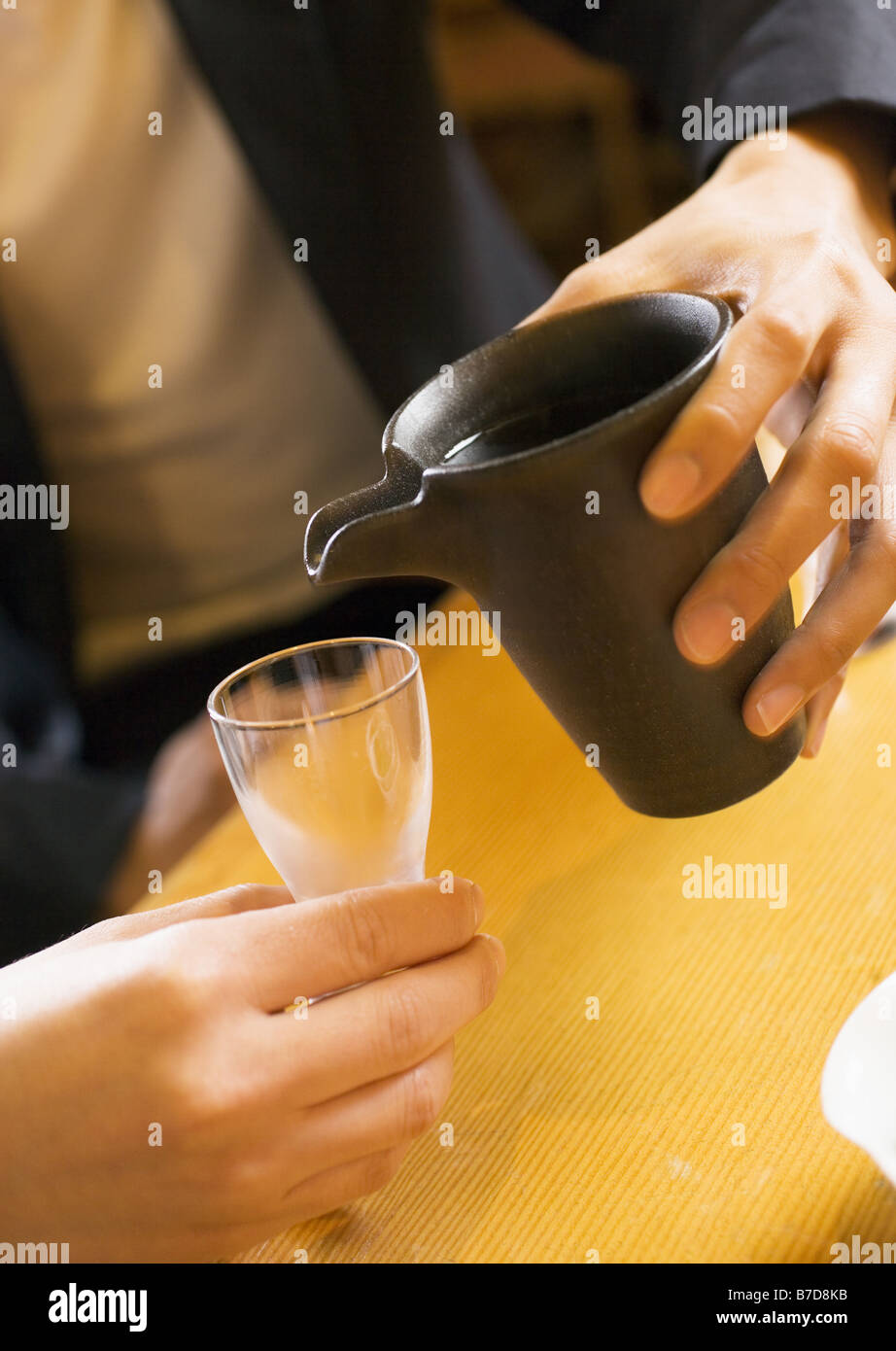 Man Pouring Japanese Sake Stock Photo - Alamy