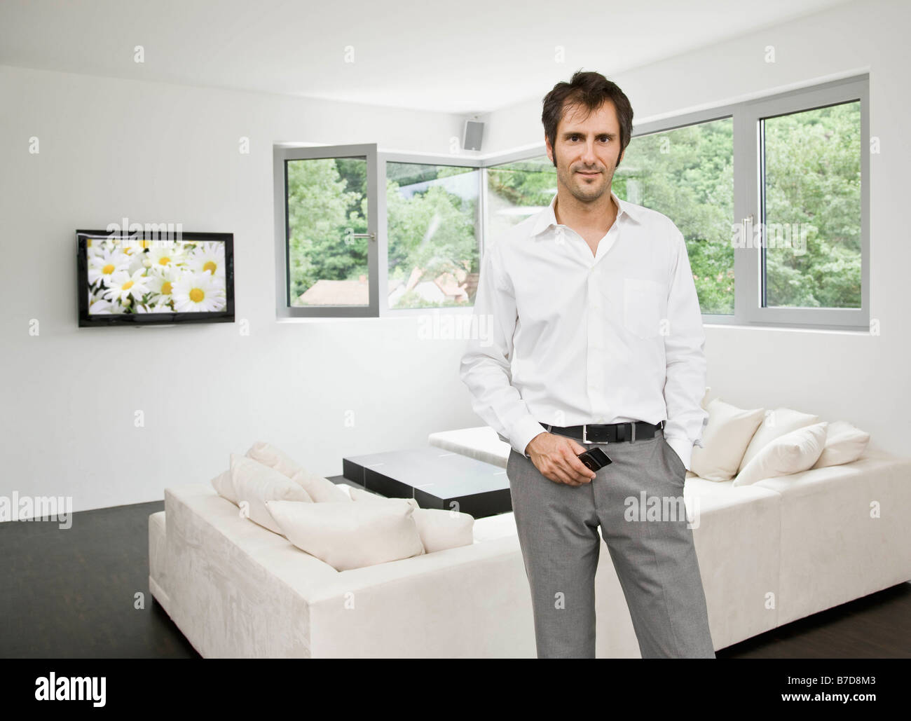 Portrait of man in living room Stock Photo - Alamy
