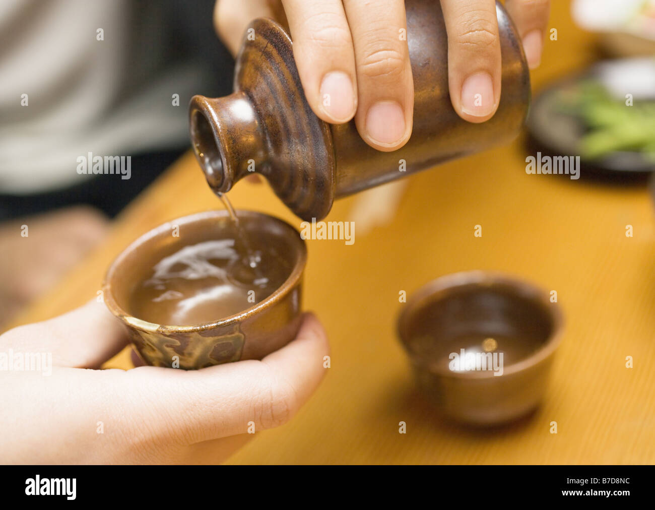 Man Pouring Sake Stock Photo - Alamy