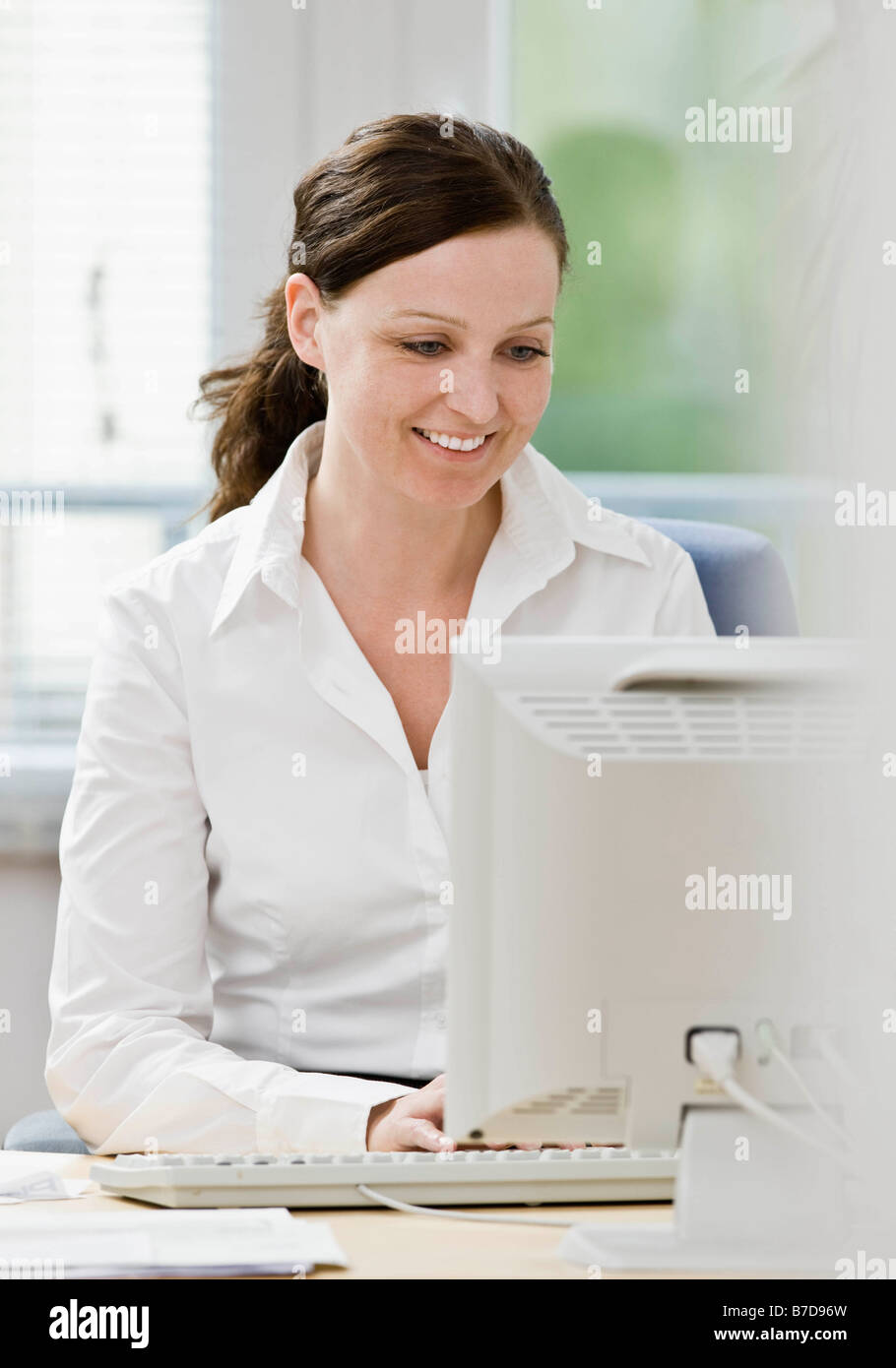 Woman working on computer Stock Photo - Alamy