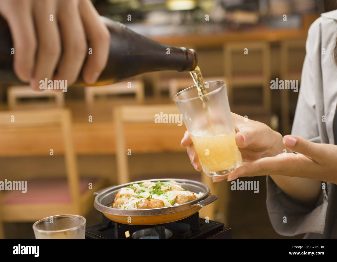 Man's Hand Pouring Beer Stock Photo - Alamy