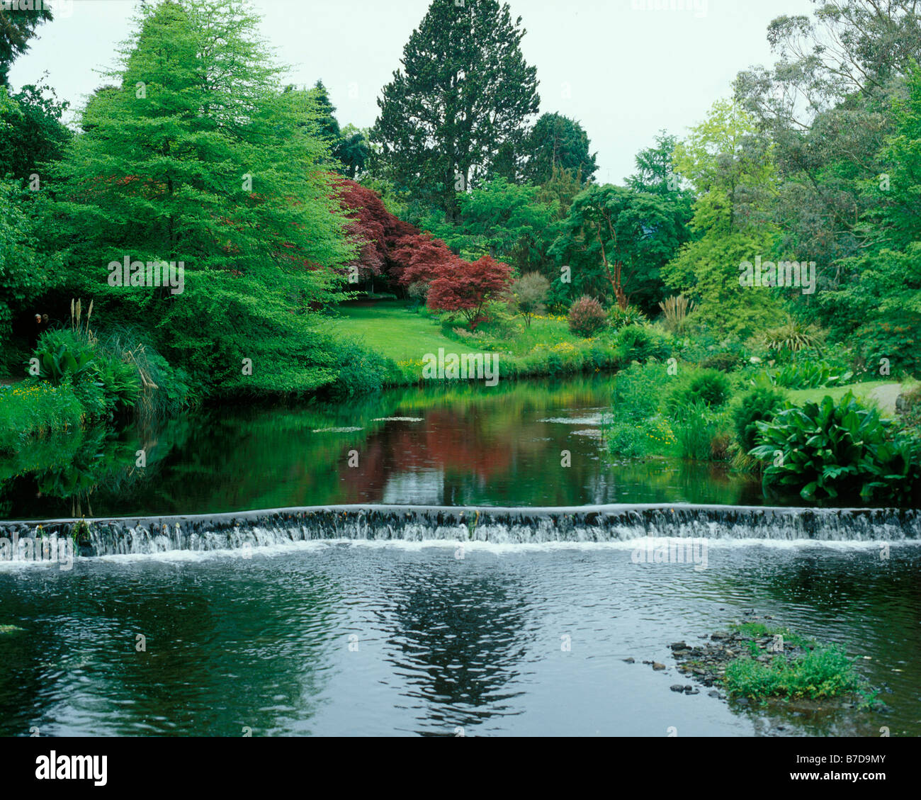 SMALL WEIR ACROSS RIVER RAISES WATER LEVEL AND SLOWS FLOW Stock Photo ...
