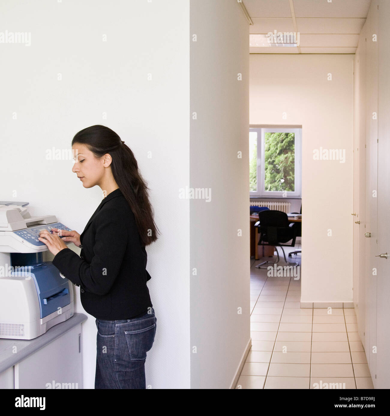Worker using copier in busy office Stock Photo - Alamy