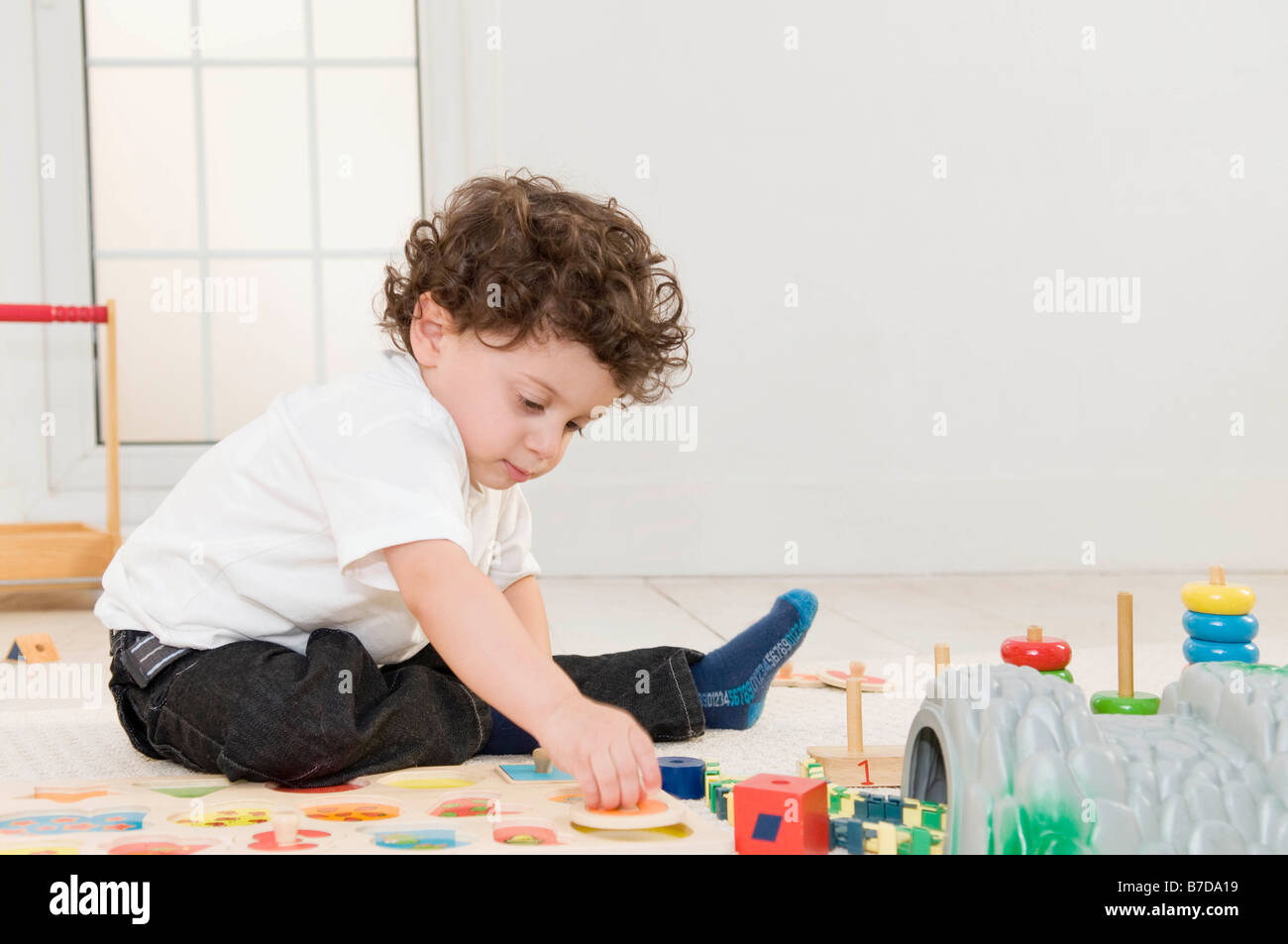 A boy playing with his toys Stock Photo - Alamy