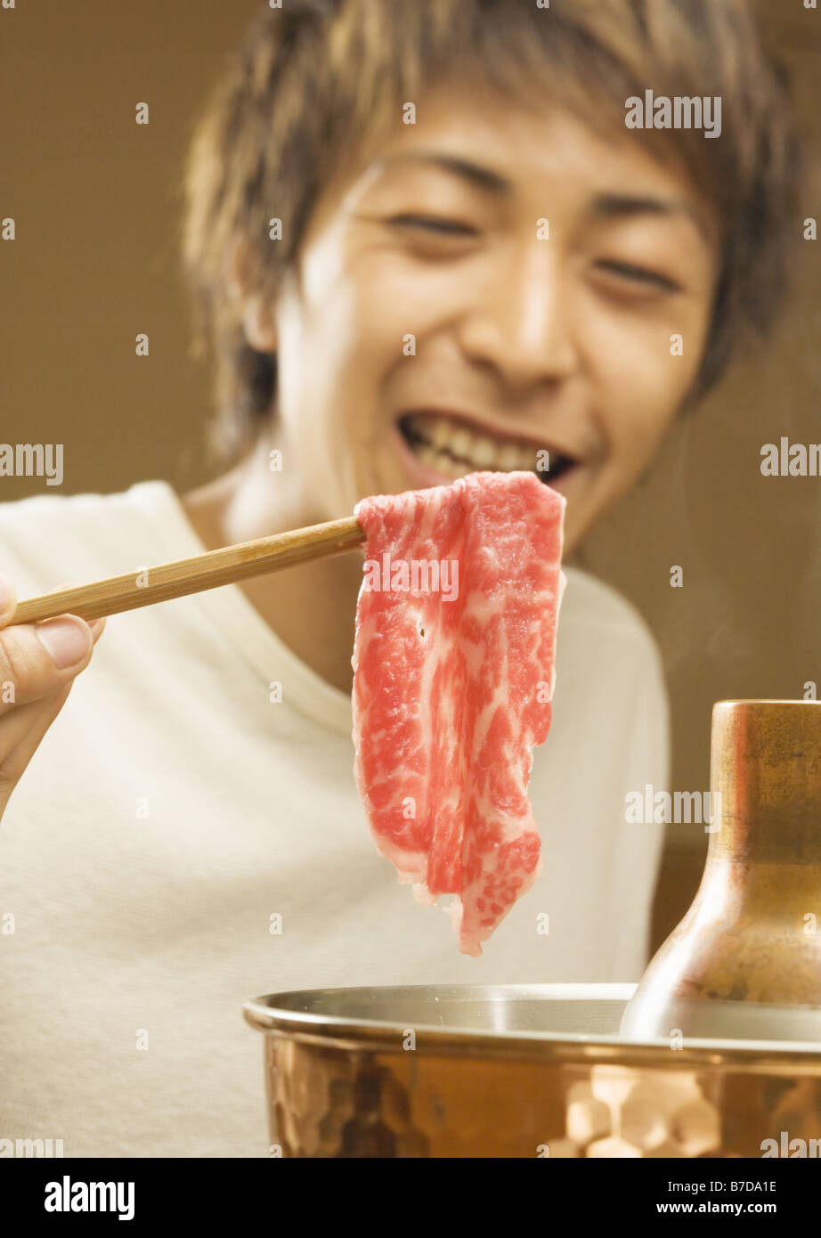 Man Eating Beef One-Pot Stock Photo - Alamy