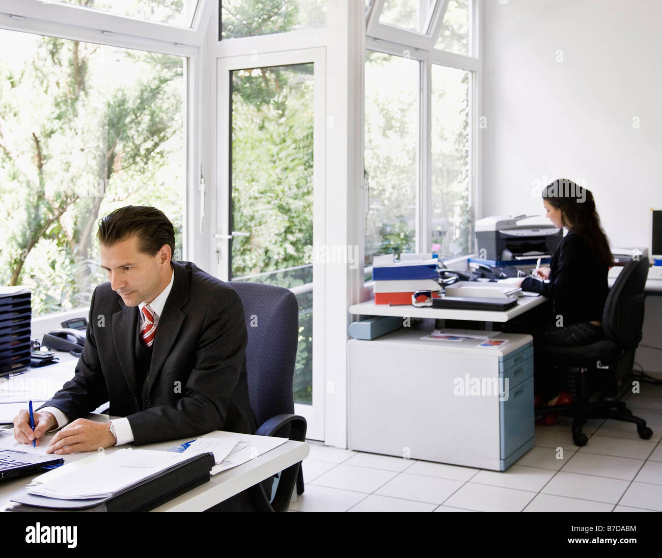 Workers in busy office Stock Photo - Alamy
