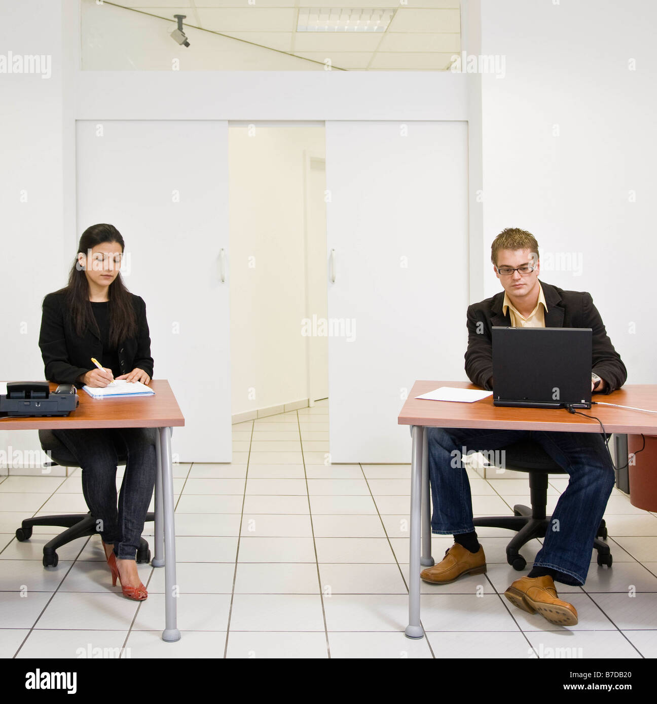 Co-workers at desk in office Stock Photo - Alamy