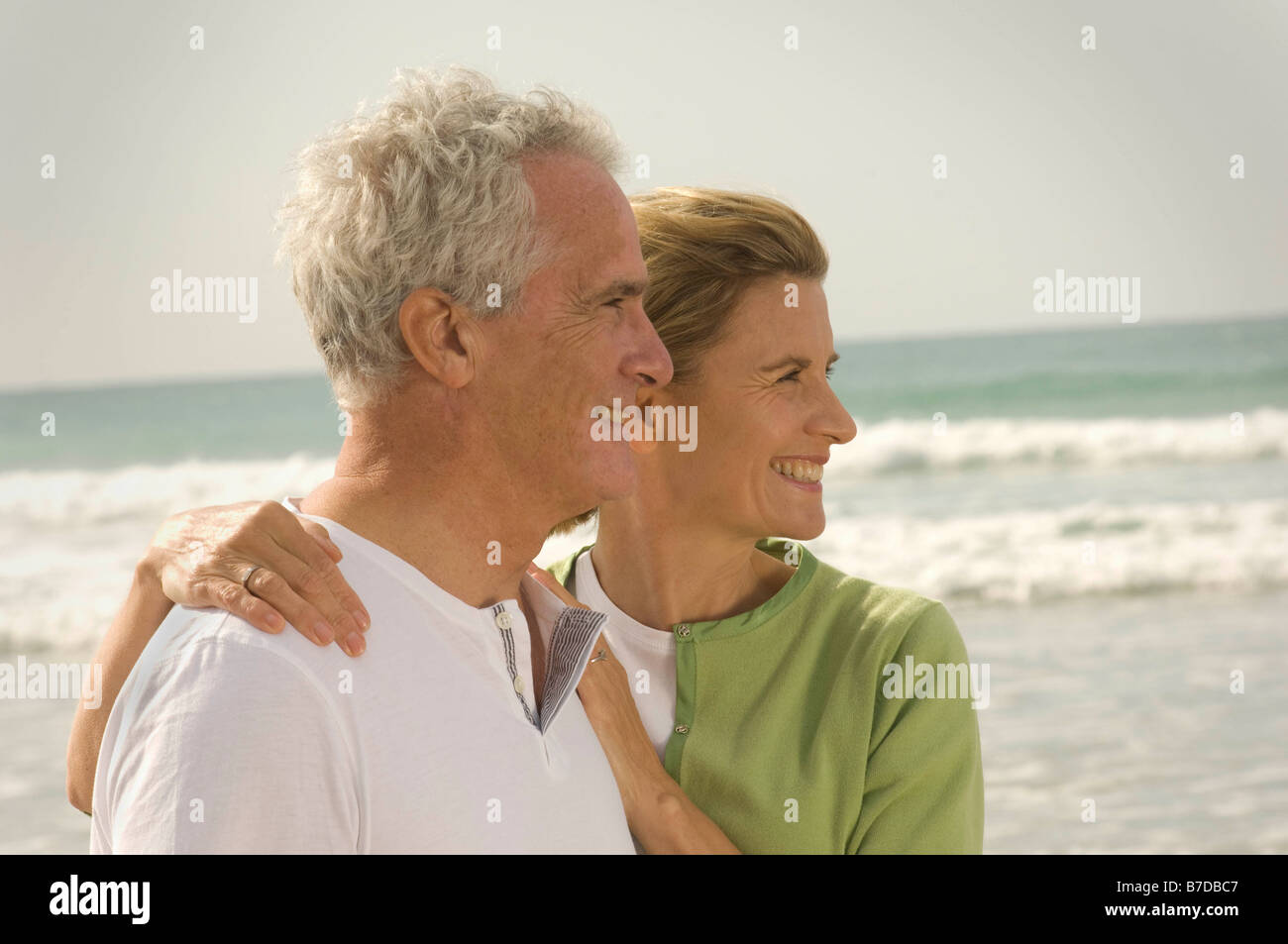 Side profile of a woman standing on the beach hi-res stock photography ...