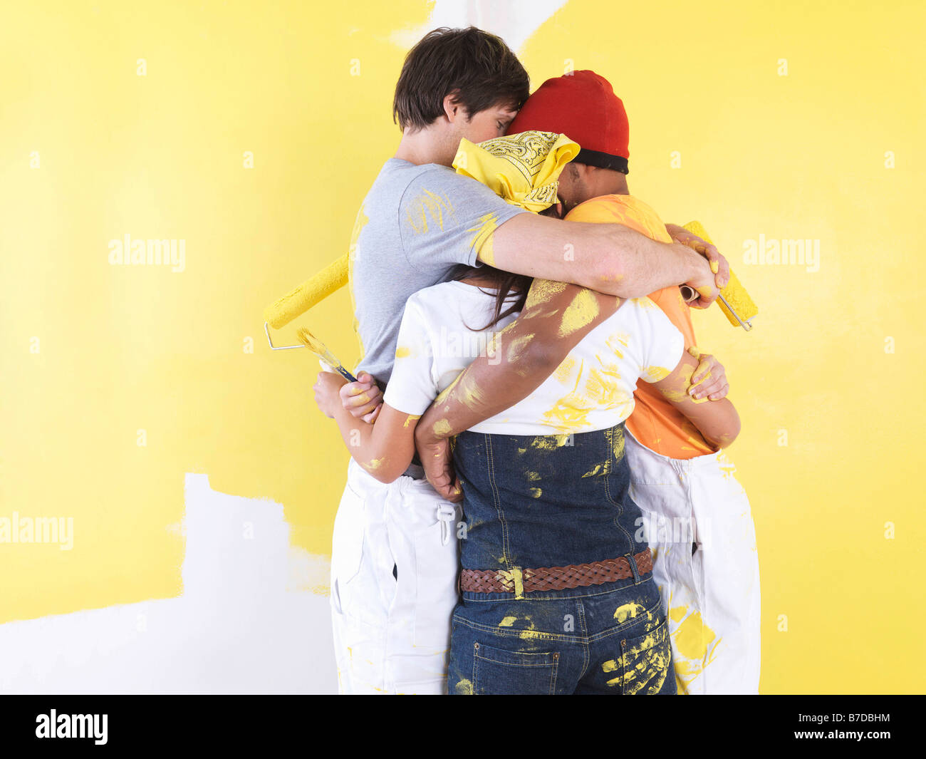 Group hugging in front of wall Stock Photo - Alamy