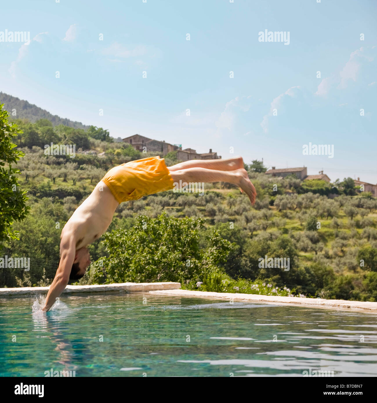 Man diving in to a pool Stock Photo - Alamy