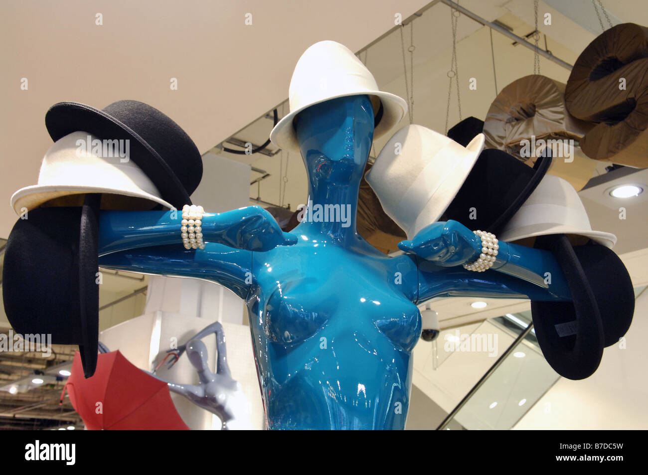 A display of Hats in Top Shop on a blue shop mannequin Stock Photo - Alamy