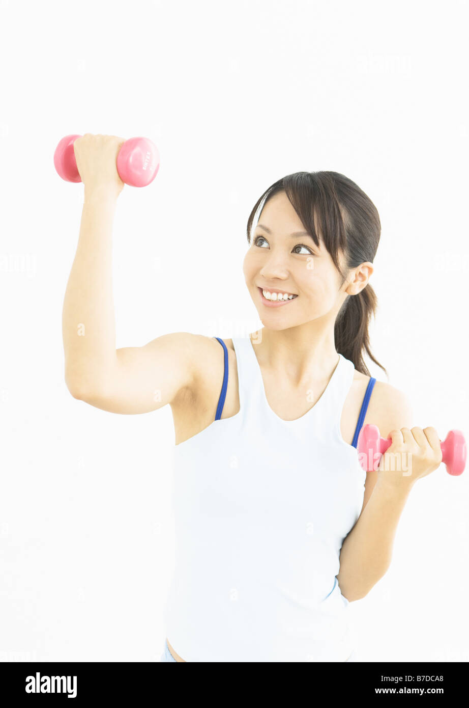 Woman doing exercise with dumbbells Stock Photo - Alamy