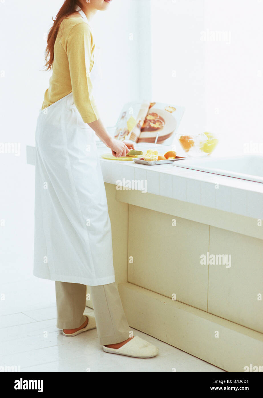 Woman in kitchen Stock Photo - Alamy