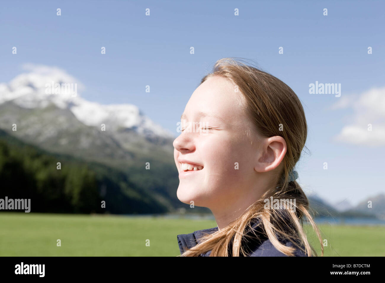 girl sitting in mountain scenery Stock Photo - Alamy