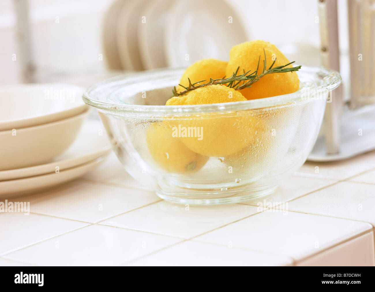 Lemons in glass bowl and dishes Stock Photo - Alamy