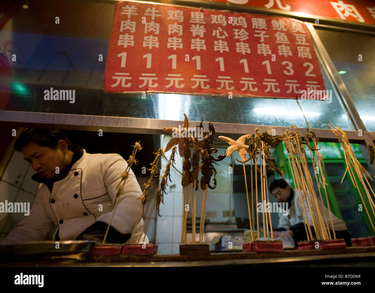 Traditional snacks for sale at night food market stall on Wangfujing ...