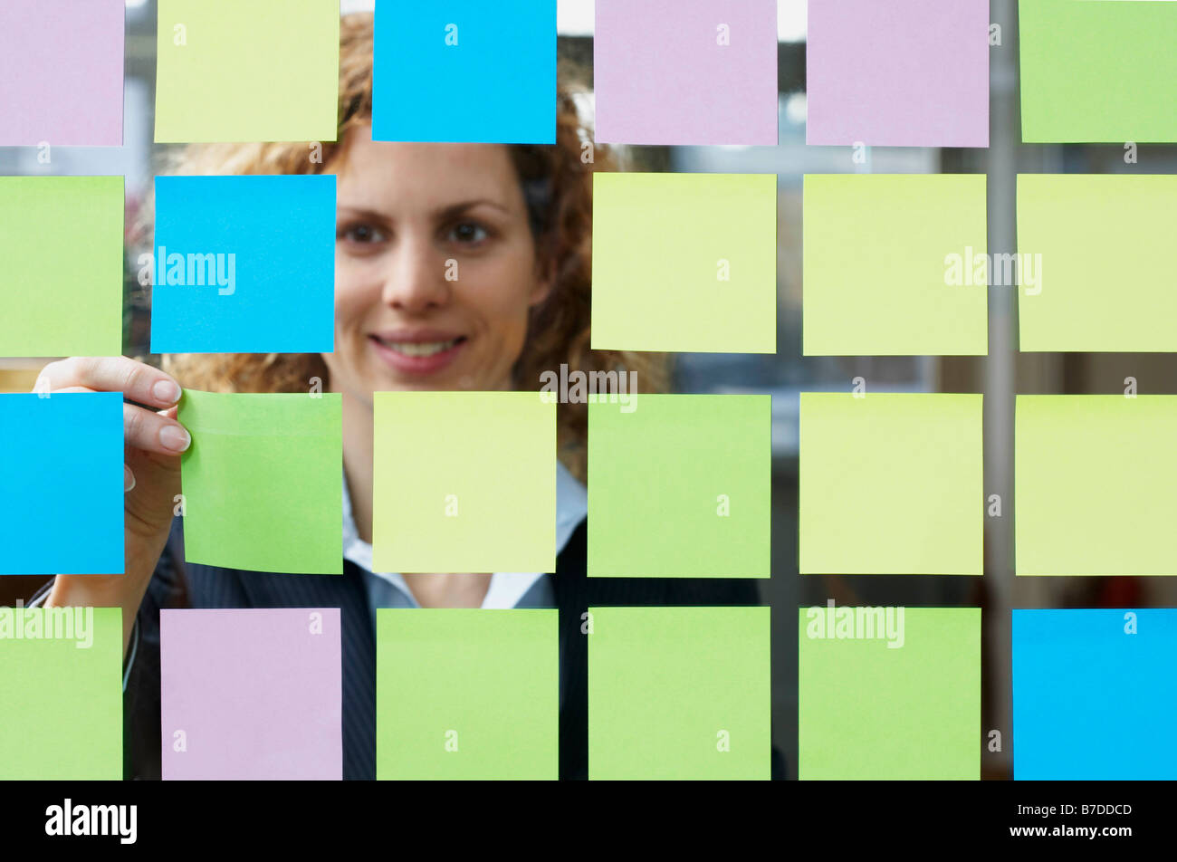 Glass full of coloured sticky notes Stock Photo - Alamy