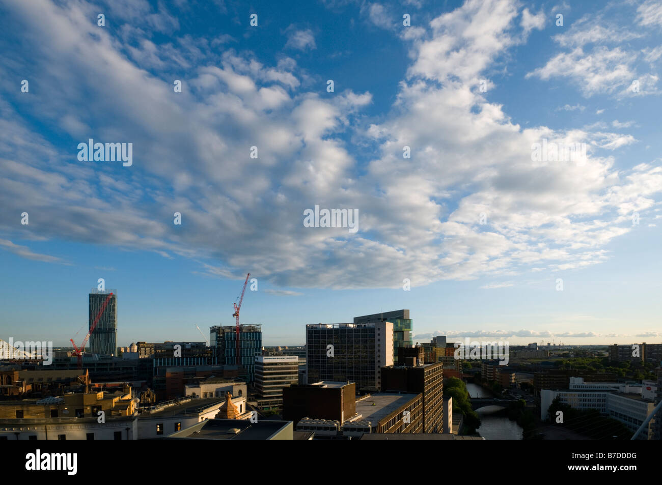 View over rooftops and the river Irwell from a city centre top floor ...