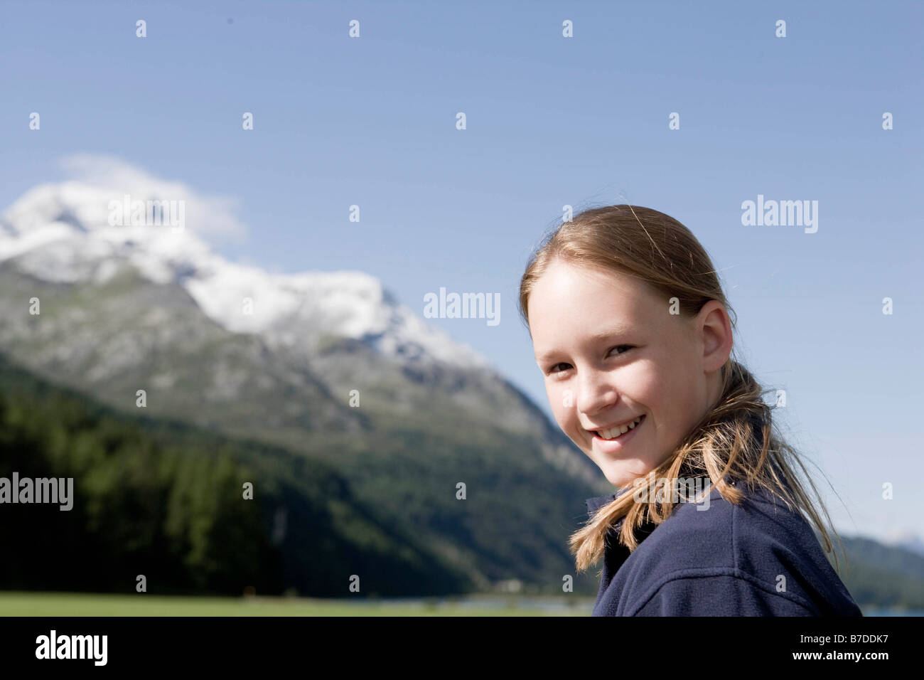 girl sitting within mountain scenery Stock Photo - Alamy