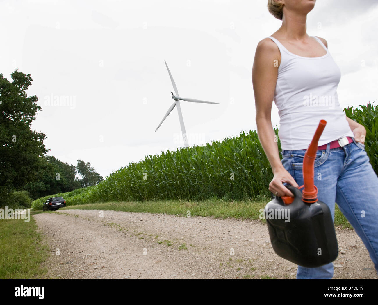 Woman walking with a gas can Stock Photo - Alamy